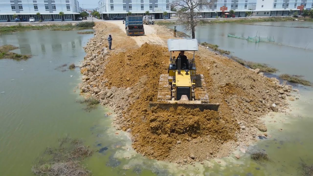 Great Talent Bulldozer At Work For road Building Across Water And ...