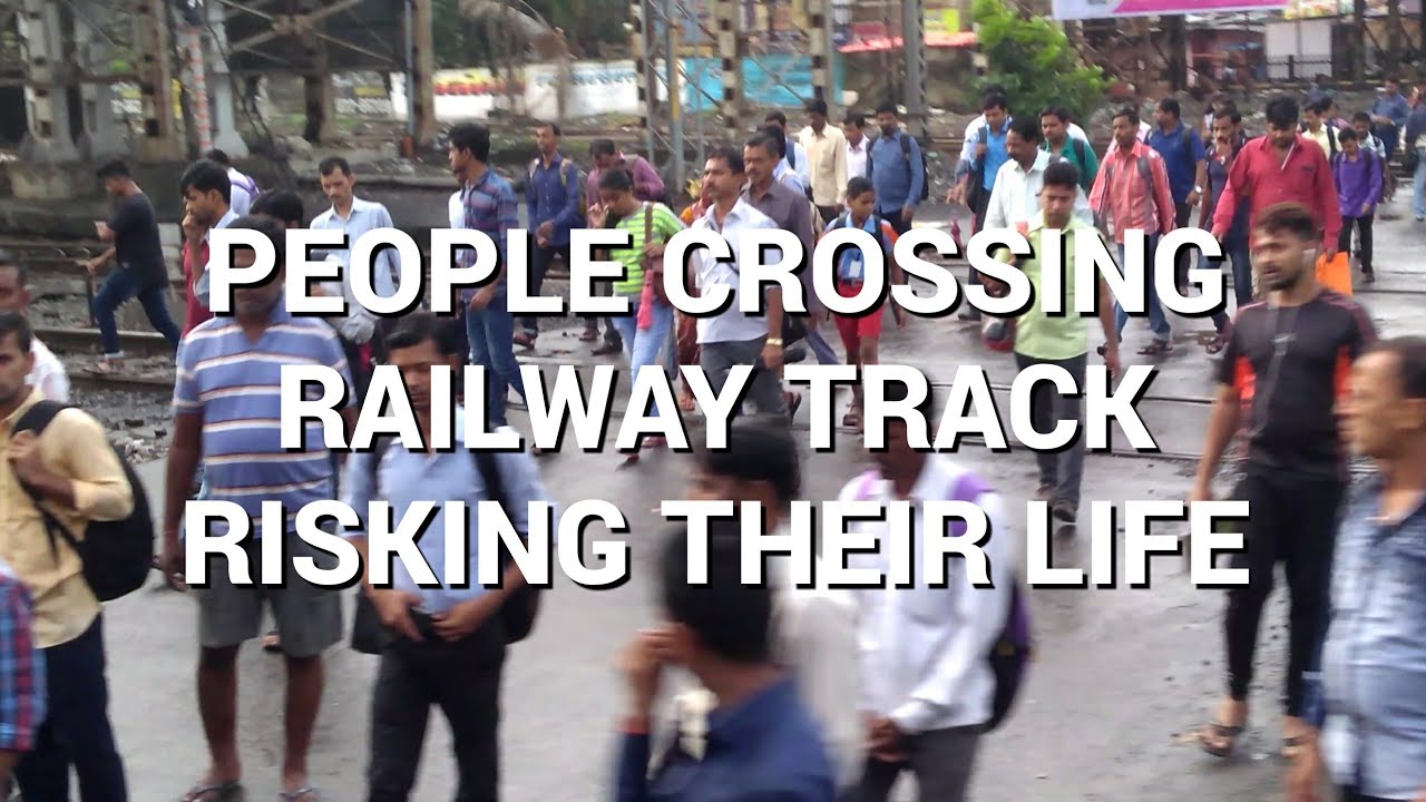 People crossing railway track when the train passes Diva Junction ...