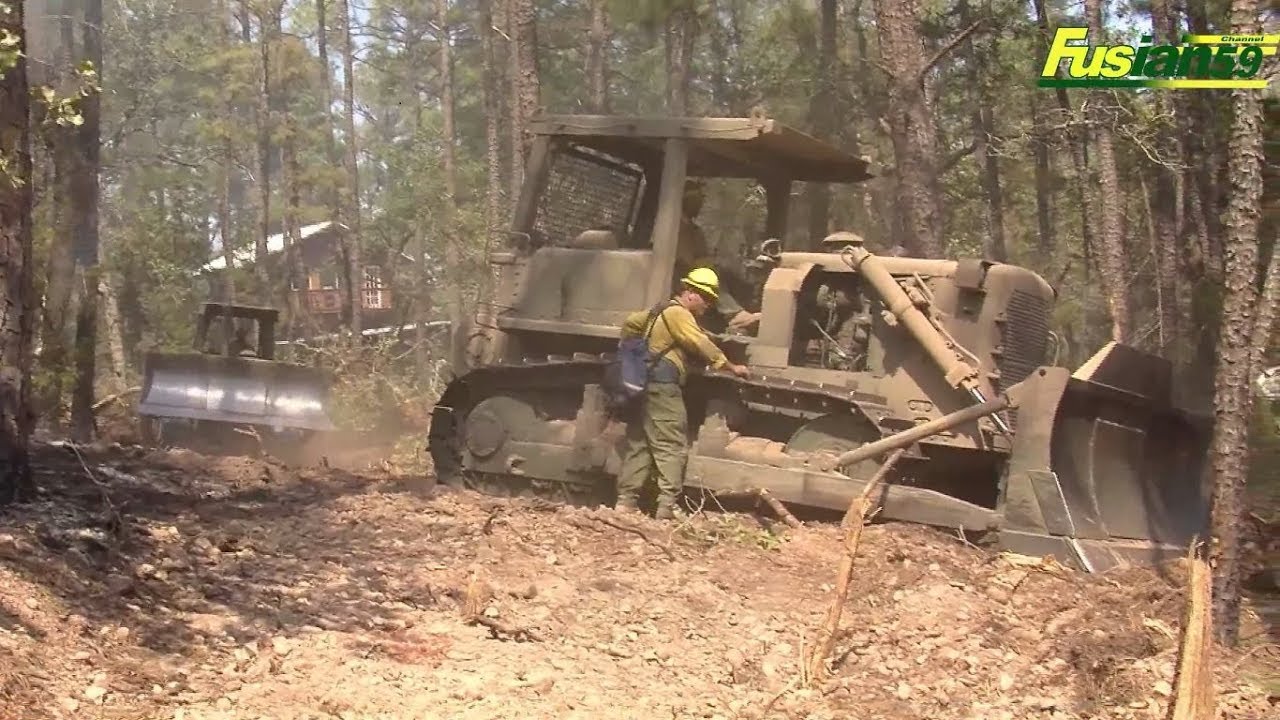 American military bulldozer heavy equipment toppled trees that burned ...