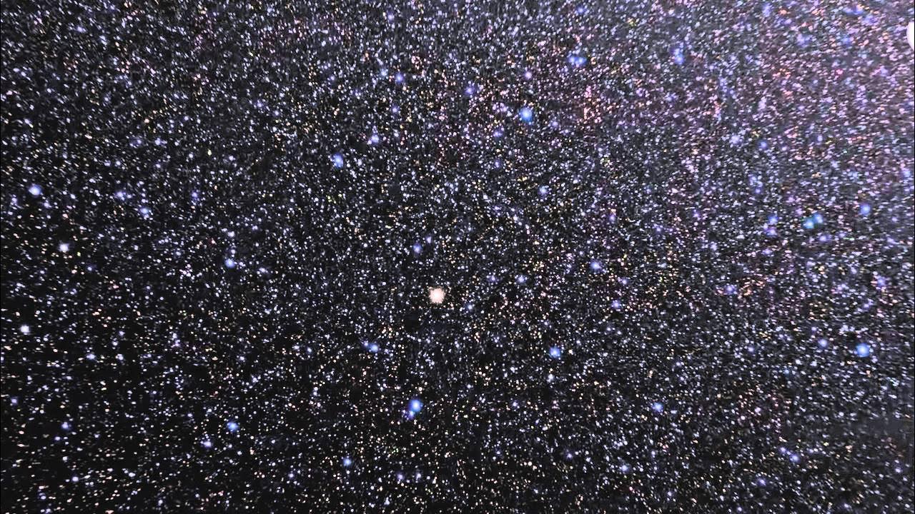 Zooming in on the globular star cluster Messier 55 - YouTube