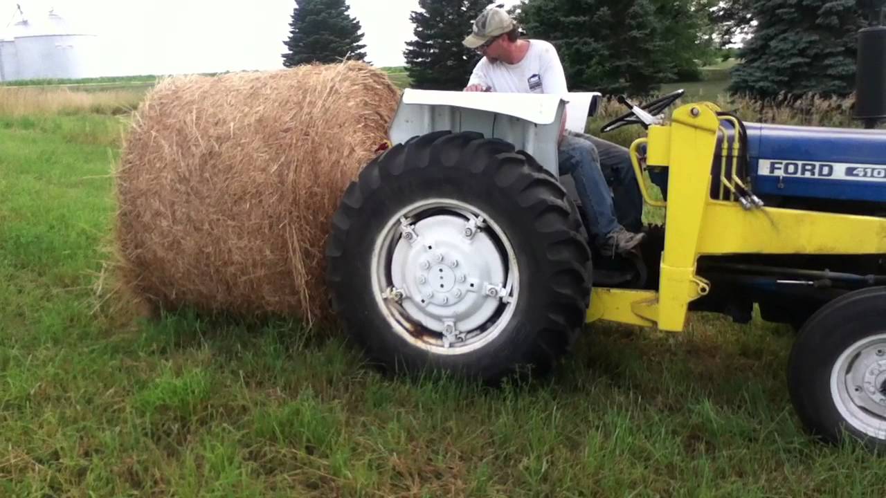 moving round hay bales - YouTube