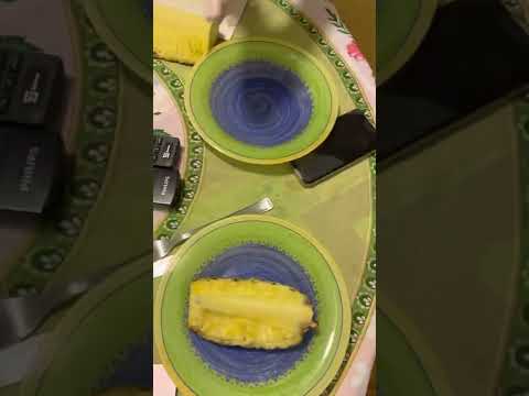 Preparing a pineapple in tight latex gloves