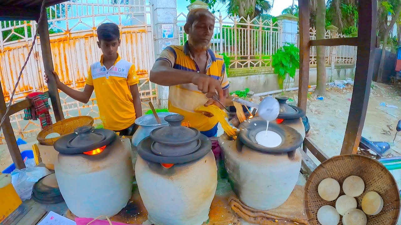 The Old Man Is Making Rice Cake (Chitoi Pitha) In Traditional Clay Oven ...