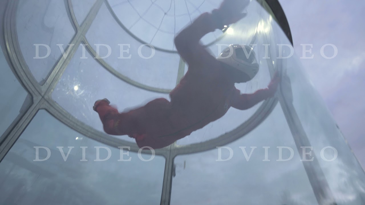 Instructor teaching young woman skydiving. Extreme parachuting in wind ...