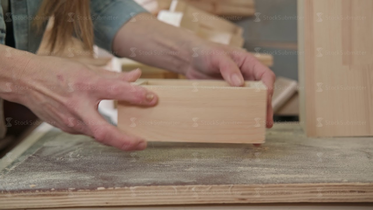Female joiner's hands: she is engaged in carpentry, handmade furniture ...