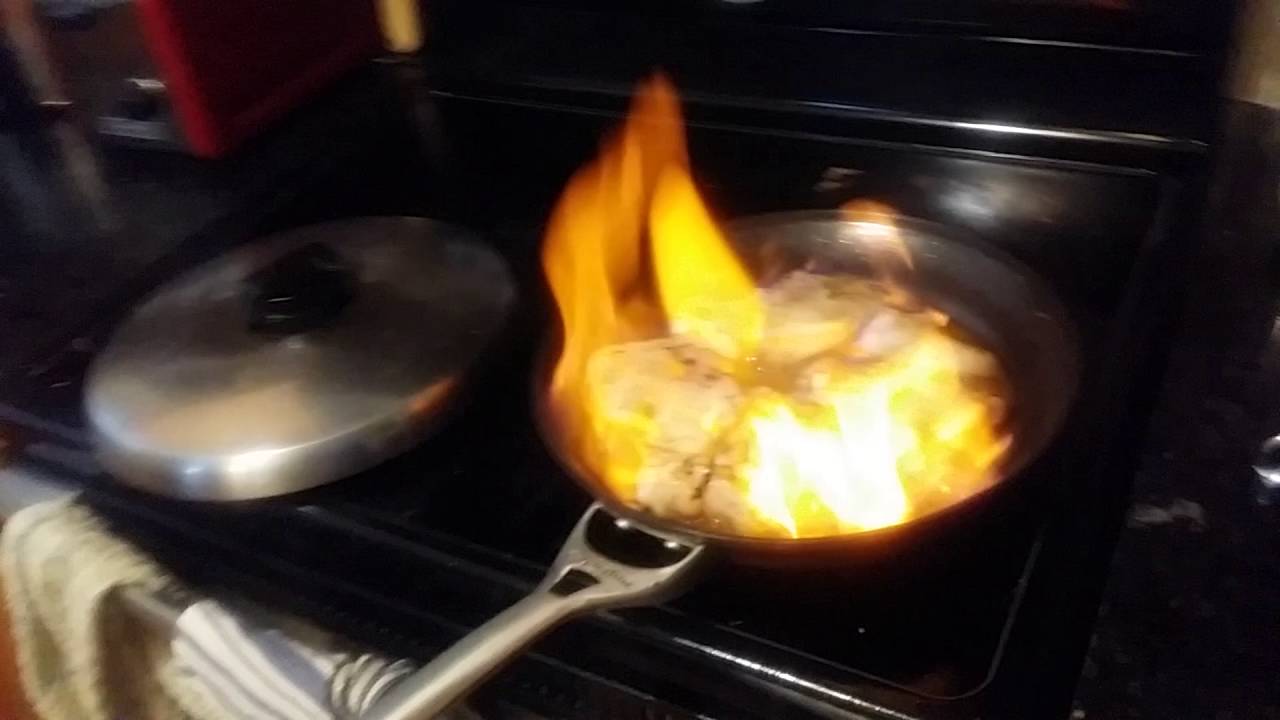 Cooking coq au vin, lighting the cognac on fire. - YouTube