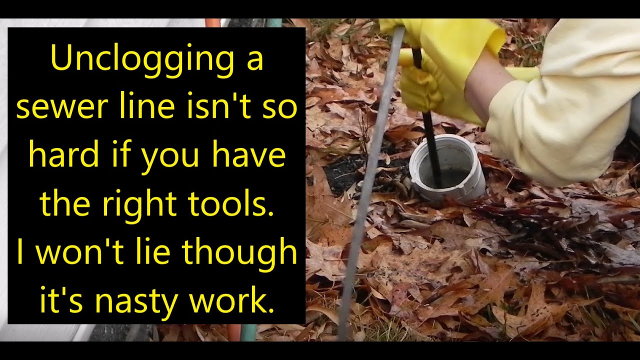 Unclogging Main Sewer Line With Hand Snake - YouTube