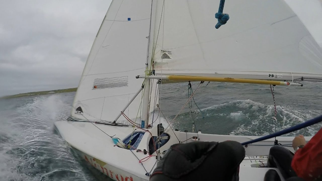 Fireball sailing in big waves and windy weather - YouTube