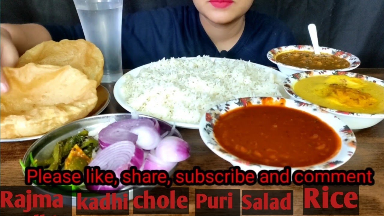 Eating spicy rajma, pakoda curry, chole, Puri (luchi) rice and salad ...