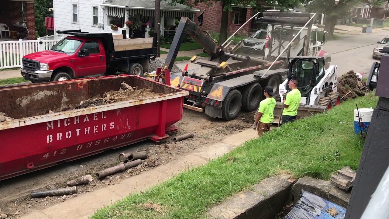 Pittsburgh Retaining Walls- Dumpster being taken away by hooklift Truck ...