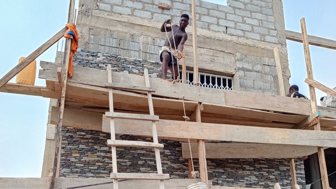 building in Ghana 2024 🇬🇭 fixing white & gray stone cladding in central ...