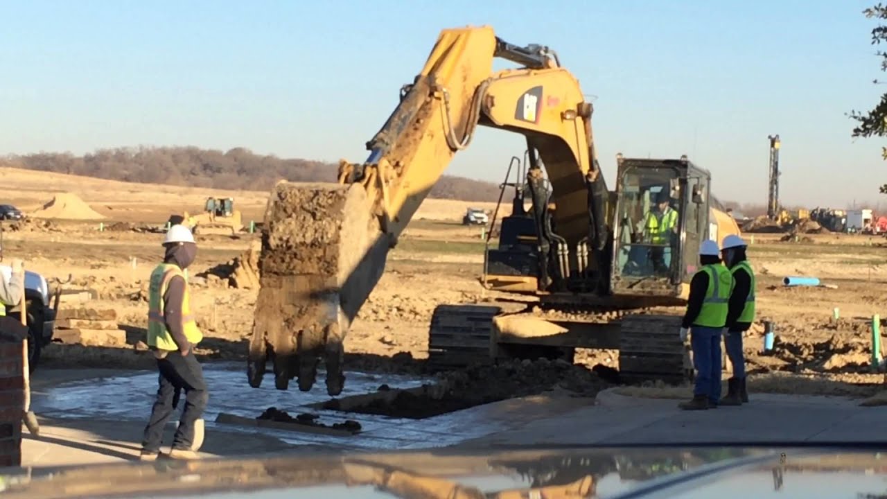 Awesome heavy equipment/track hoe working. Connecting a water line ...