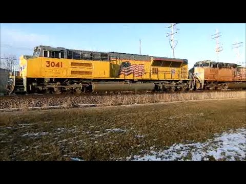 UP 3041 and UP 6066 lead a autorack train with a horn salute west through Geneva IL - YouTube