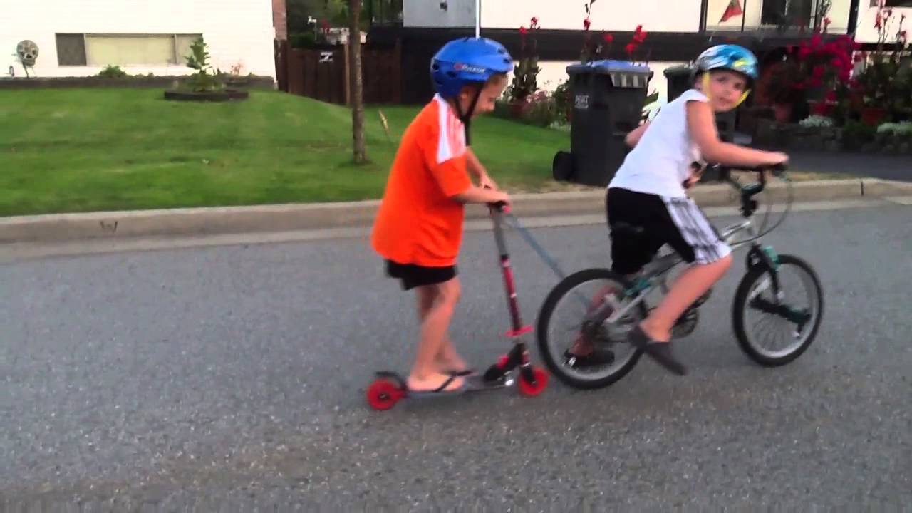 Bike pulling scooter - YouTube