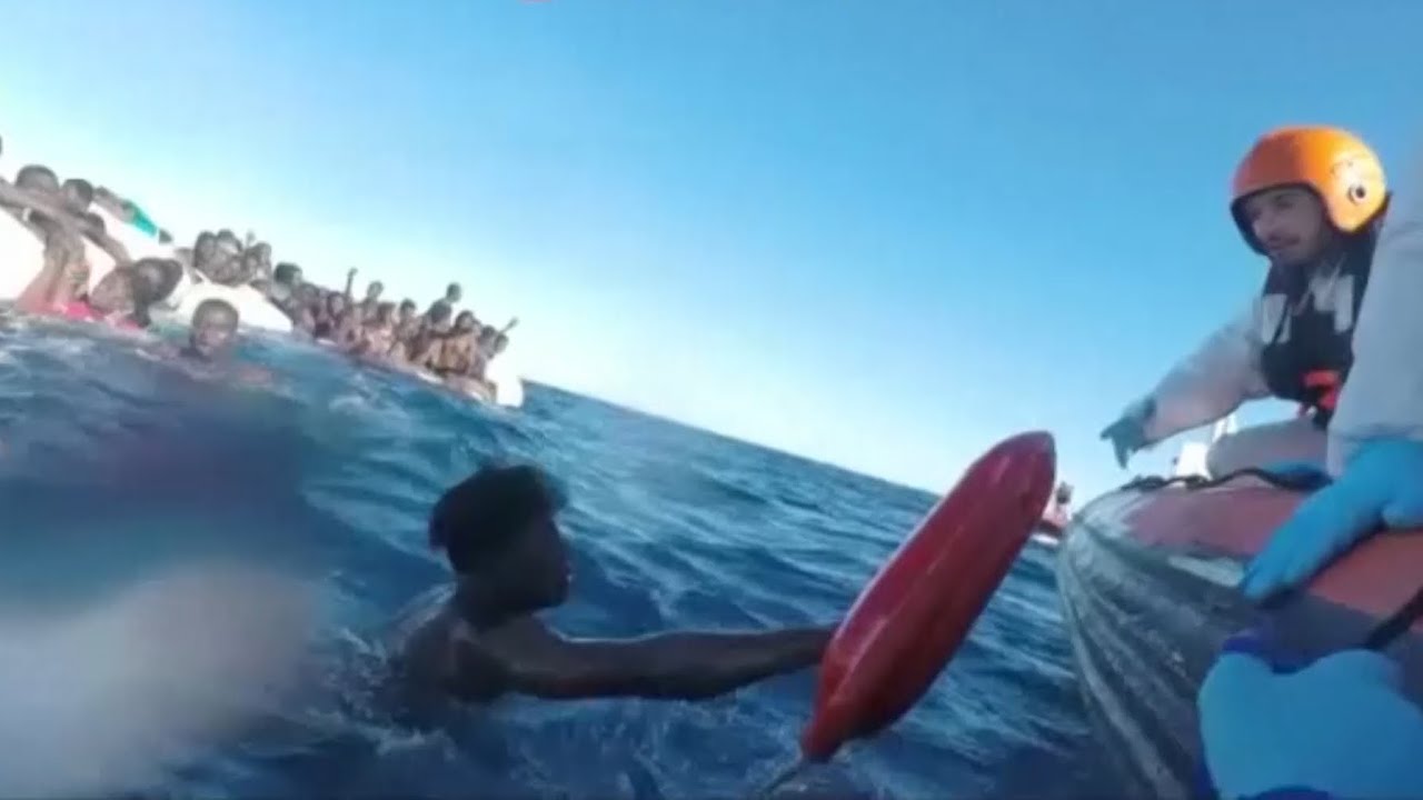 Harrowing footage shows rescue of migrants from sinking dinghy - YouTube