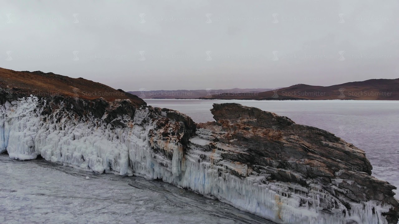 Rocks covered with ice over a frozen lake. - YouTube