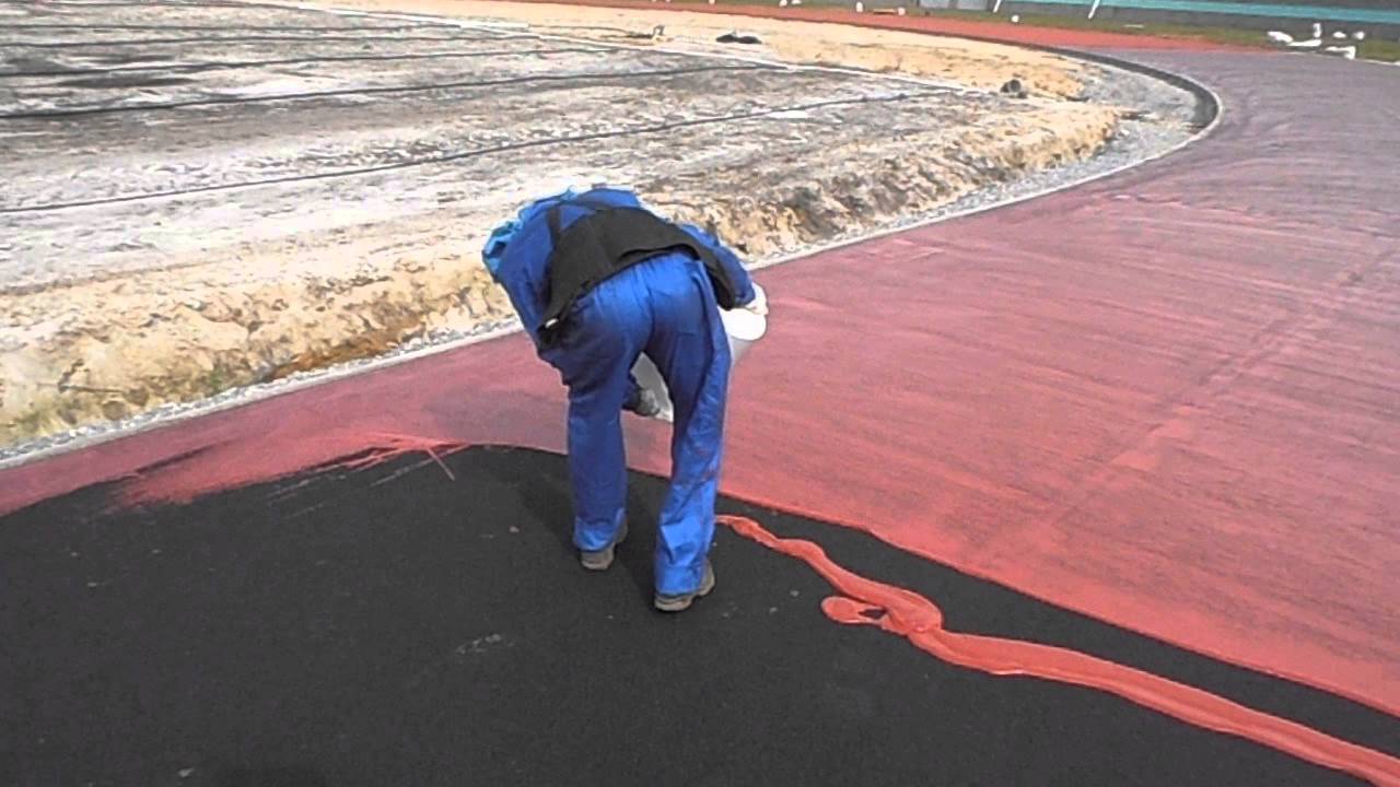 Installation pore-sealer on Manny Ramjohn athletic track - YouTube