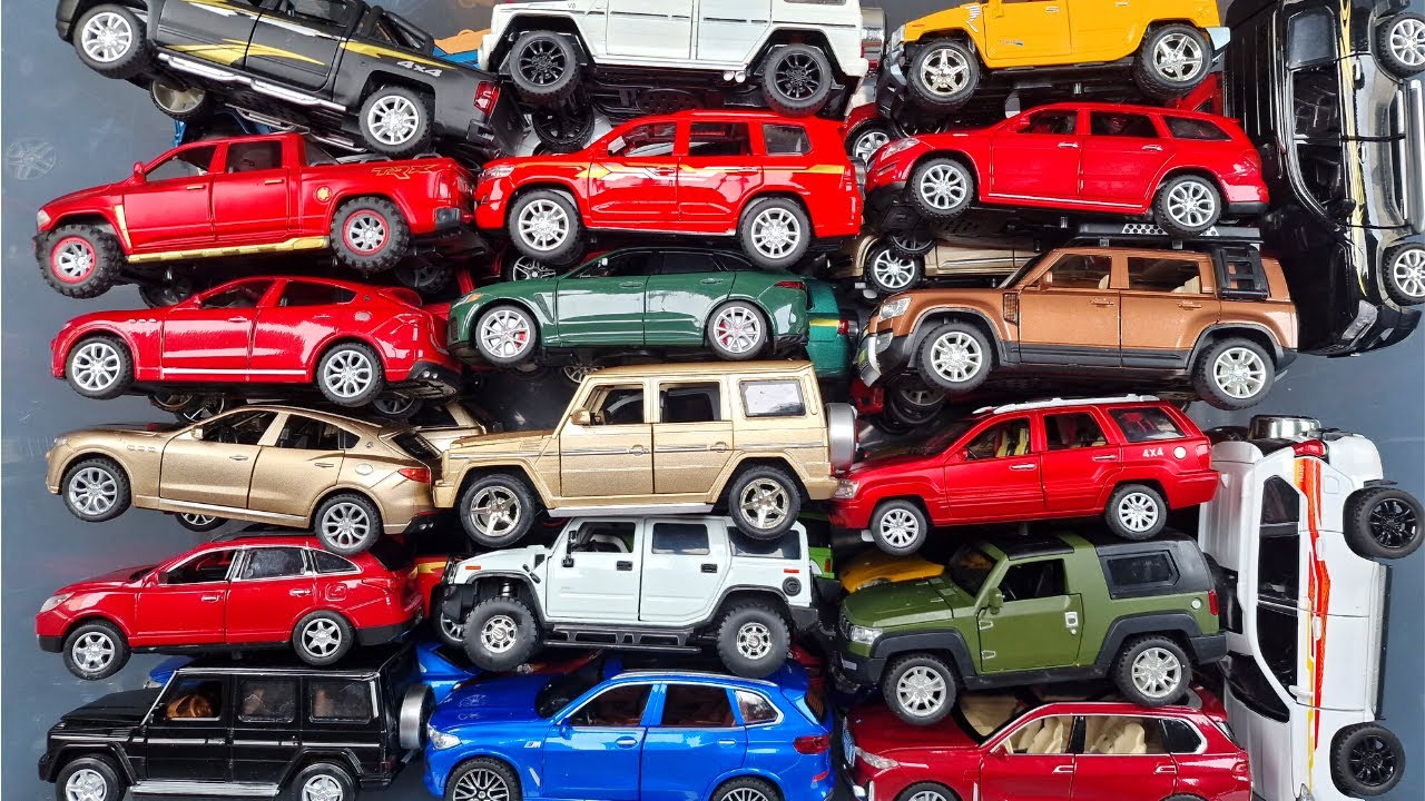 Large selection of SUV and Pick Up model cars being shown in hand ...