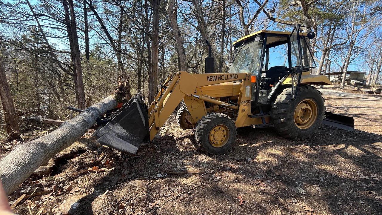 My 445D ford tractor pushed down a dead tree - YouTube