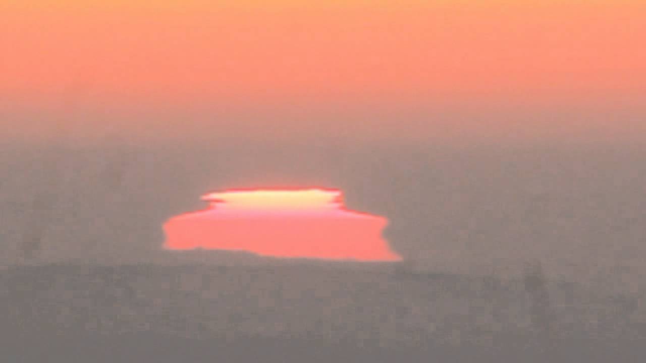 Distorted Sunrise w/ dim green flash - YouTube