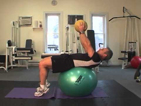 Stability ball Abdominal crunch,arms extended over chest with medicine ...