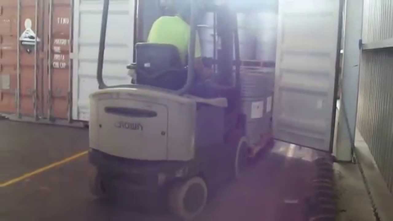 Loading pallets of drums into a container - YouTube