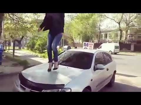 Girl jumping on car hood
