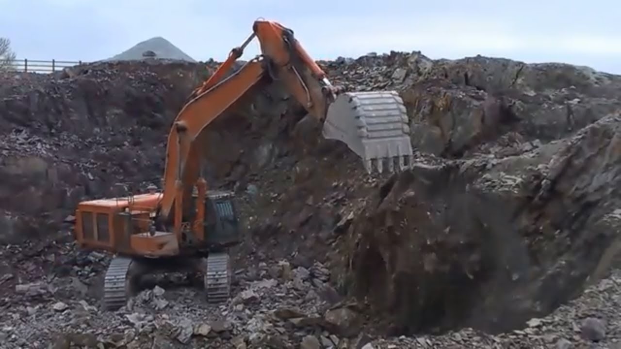 Hitachi 650 excavator loading dumpers on a road construction site #1 ...