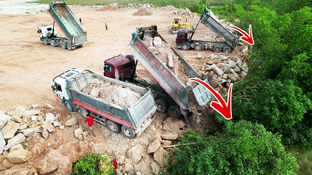 Powerful Trucks Dumping Stones bulldozer, pushing rocks ensuring smooth ...