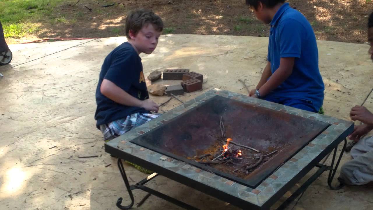Building a Campfire - Adding smaller sticks to the fire - YouTube