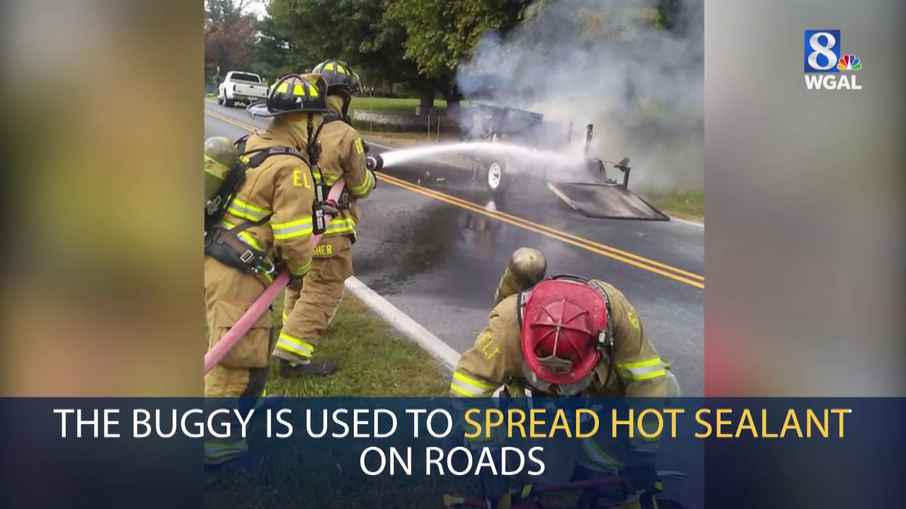 Crews clear fire on tar buggy - YouTube