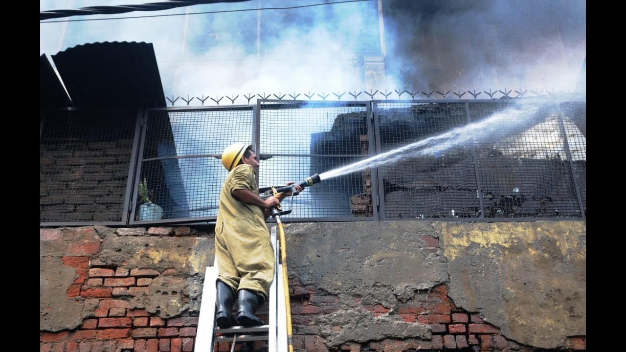 Fire brigade personnel try to douse flames in G B road area of Delhi on ...