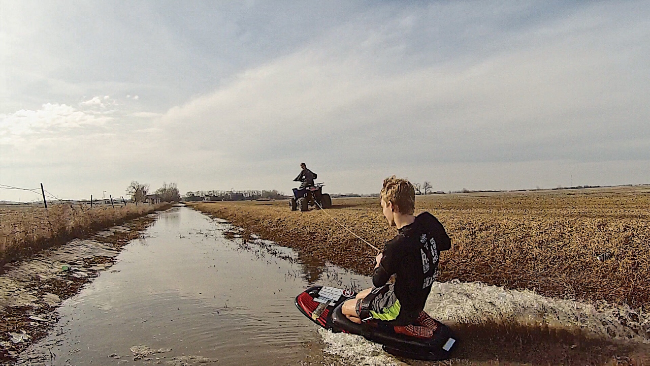 SURFING BEHIND AN ATV IN A FLOODED DITCH - YouTube