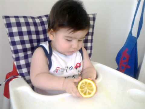 Baby plays with lemon then eats it :)