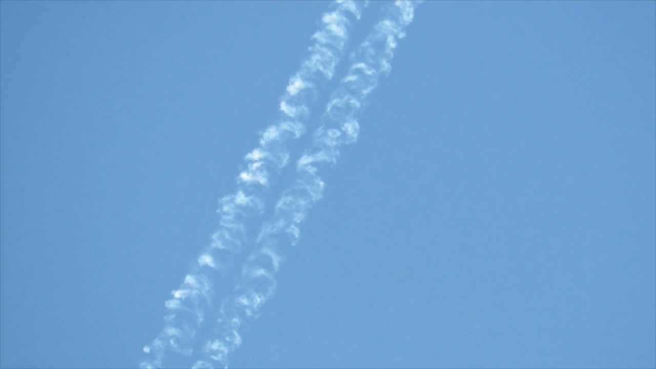Jet engine exhaust on the background of short dissipating contrail ...