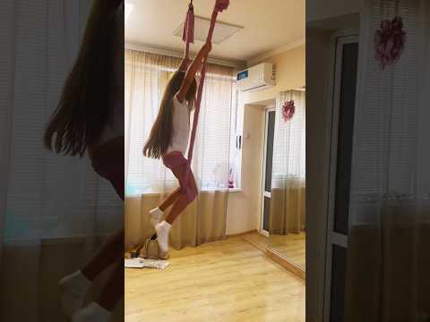 Little girl makes leg-split in air.
