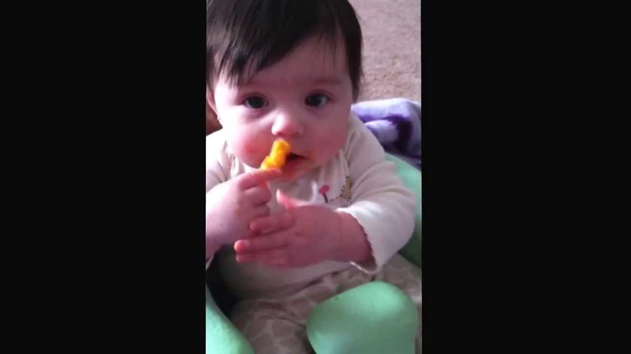 Cute baby tasting a Cheetos - YouTube
