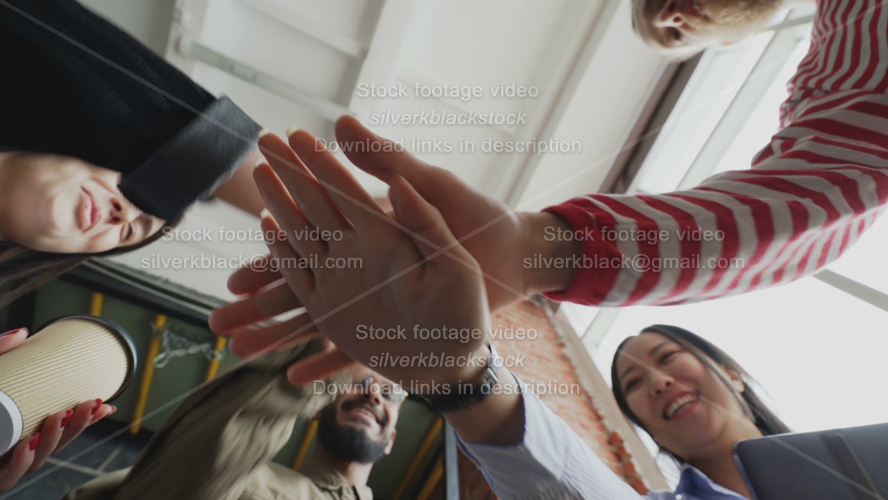 Low angle view of start-up business team of multi-ethnic people put ...