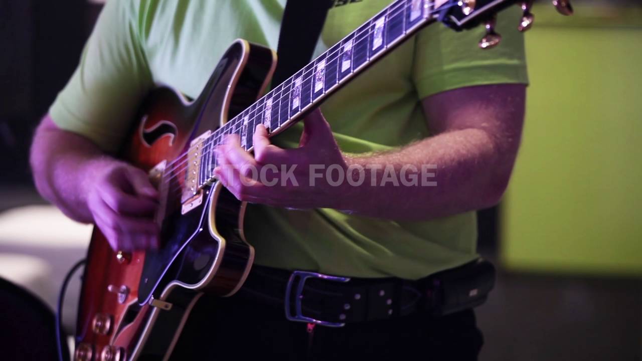 Professional guitarist playing electric guitar close up process. Video ...