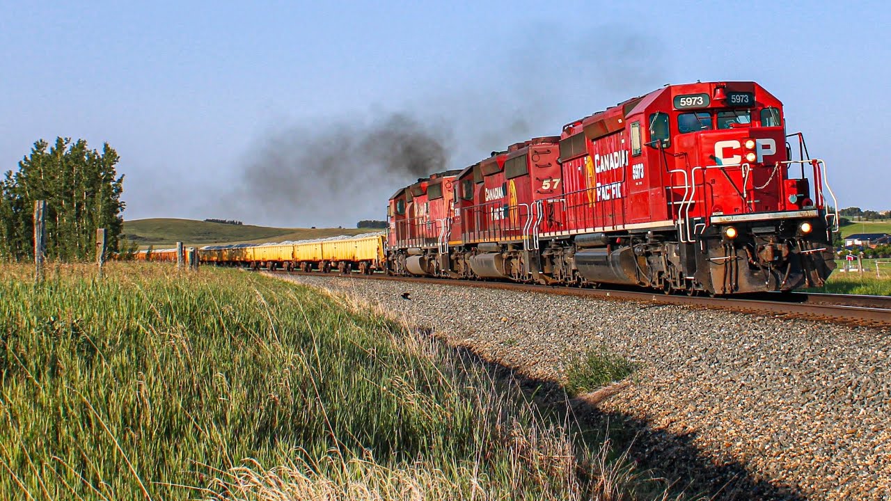 Triple SD40-2!!! CP 5973, CP 5792 and CP 5936 lead CP 2BAL North into Crossfield, Alberta - YouTube