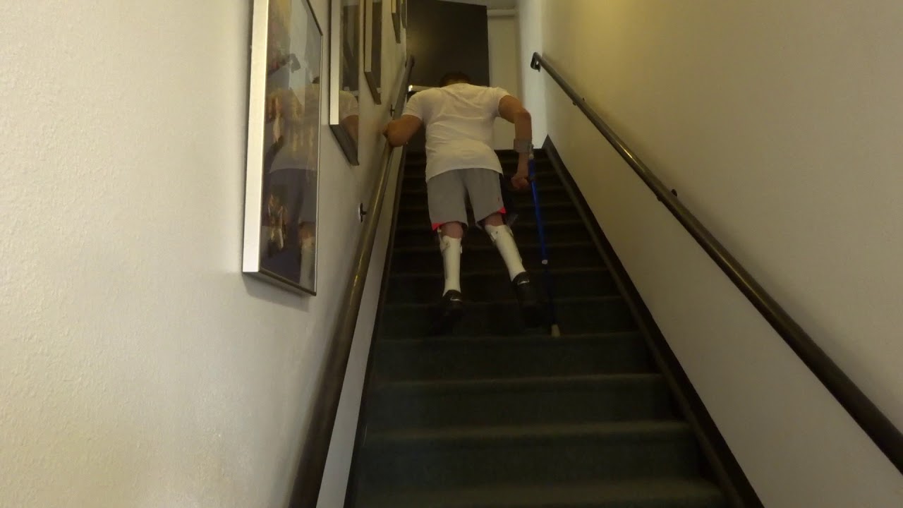 Walking Up Stairs With Leg Braces and Crutches - Rear View (Wheelchair ...