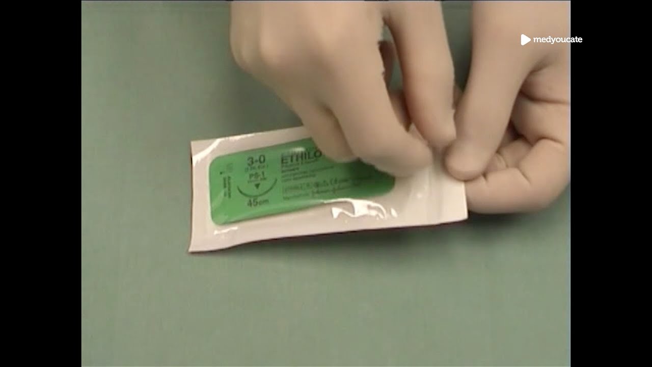 Unwrapping and Clamping a Sterile Packed Needle into the Needle Holder ...