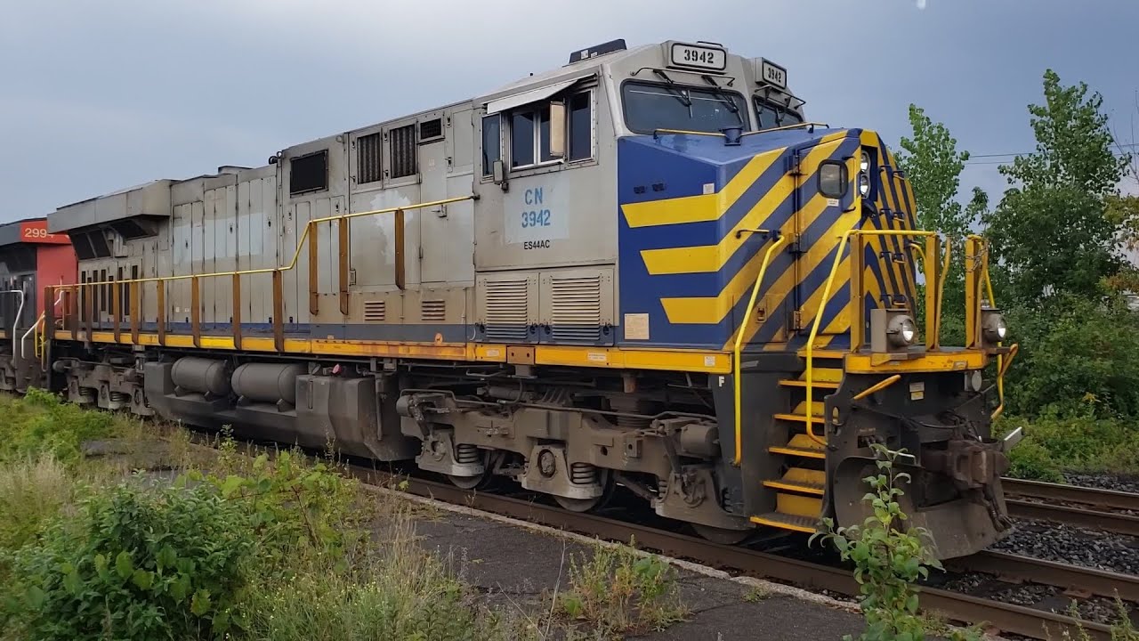 TRAINS Unsettled Sky CN Westbound Freight With Ex Citirail ES44AC Leading at Dorval - YouTube