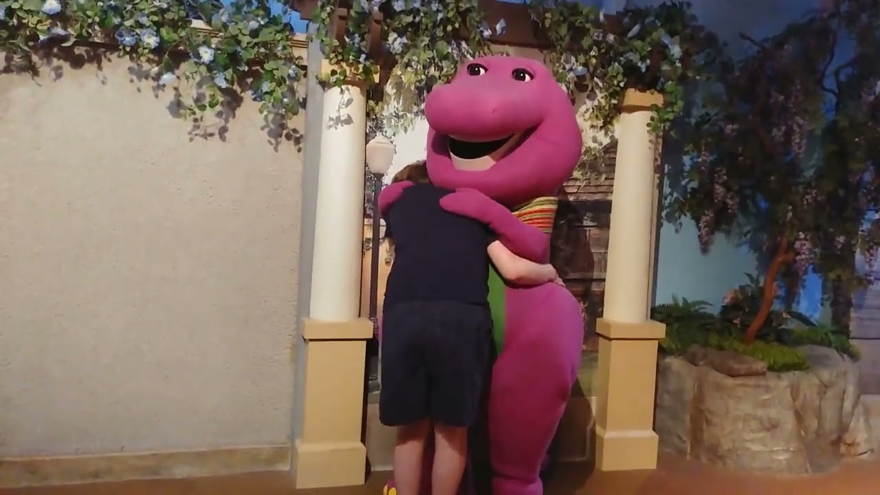 Joel having a big long hug with Barney the dinosaur at universal ...