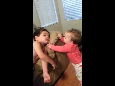 Baby sister tries to wake her big brother