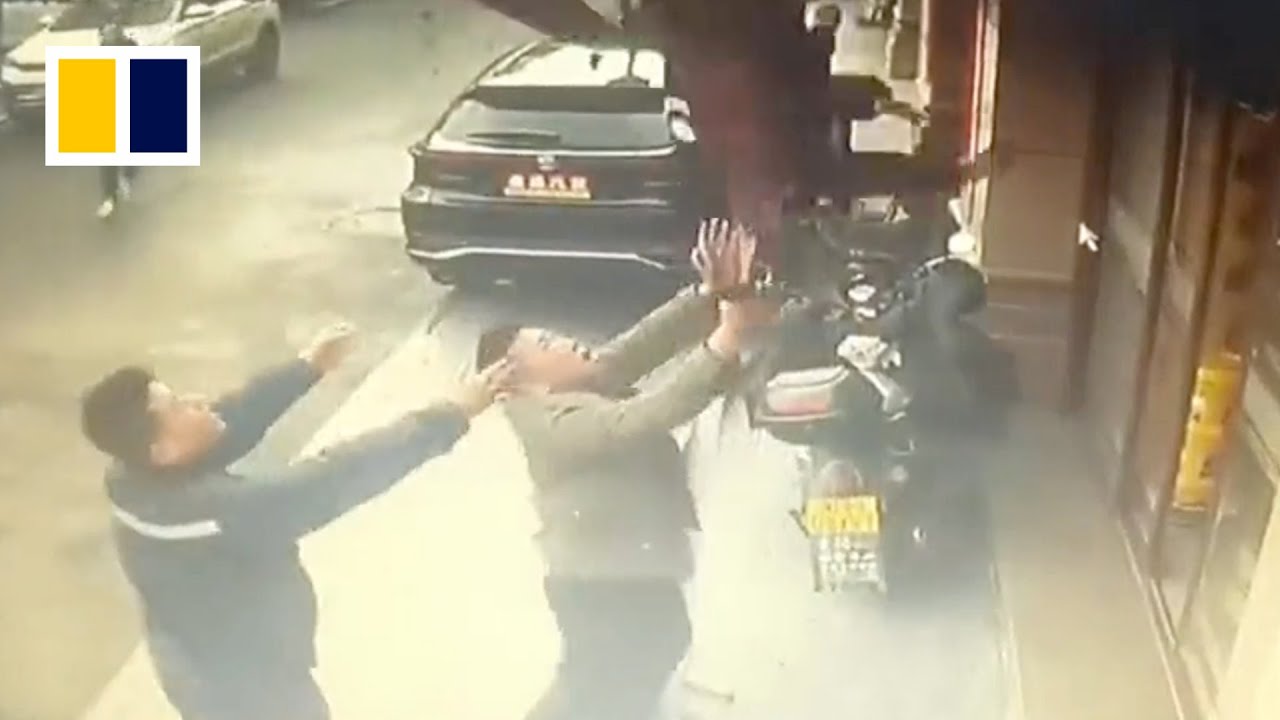 Heroic man catches falling boy in China - YouTube