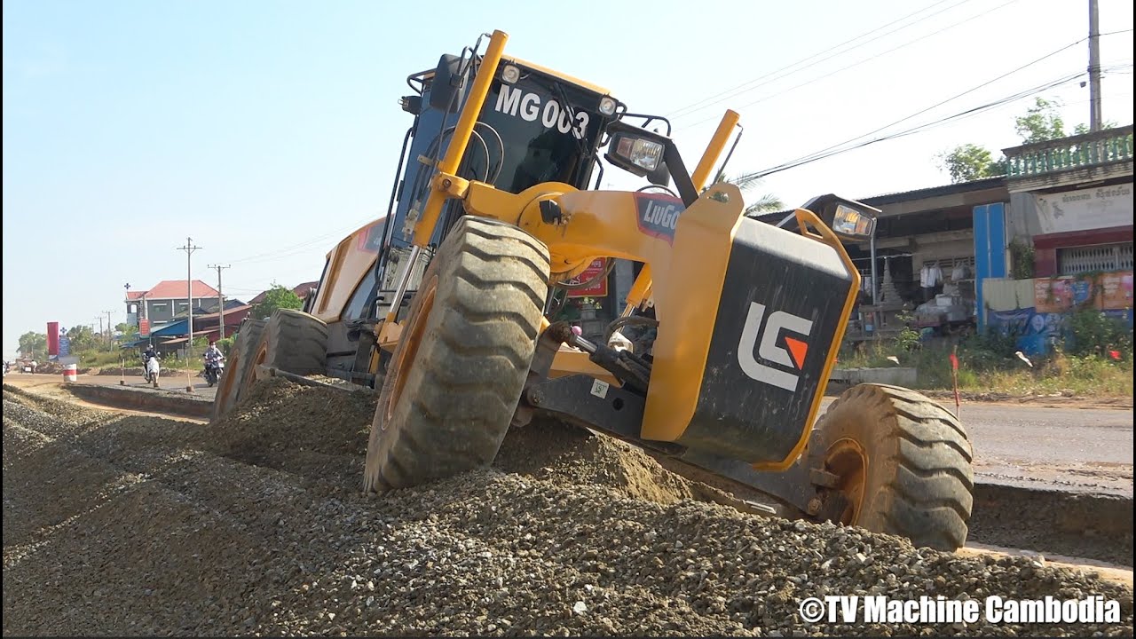 New motor grader grading gravel with driver skill on road ...