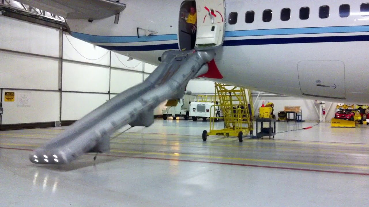 Aircraft escape slide deployment - YouTube