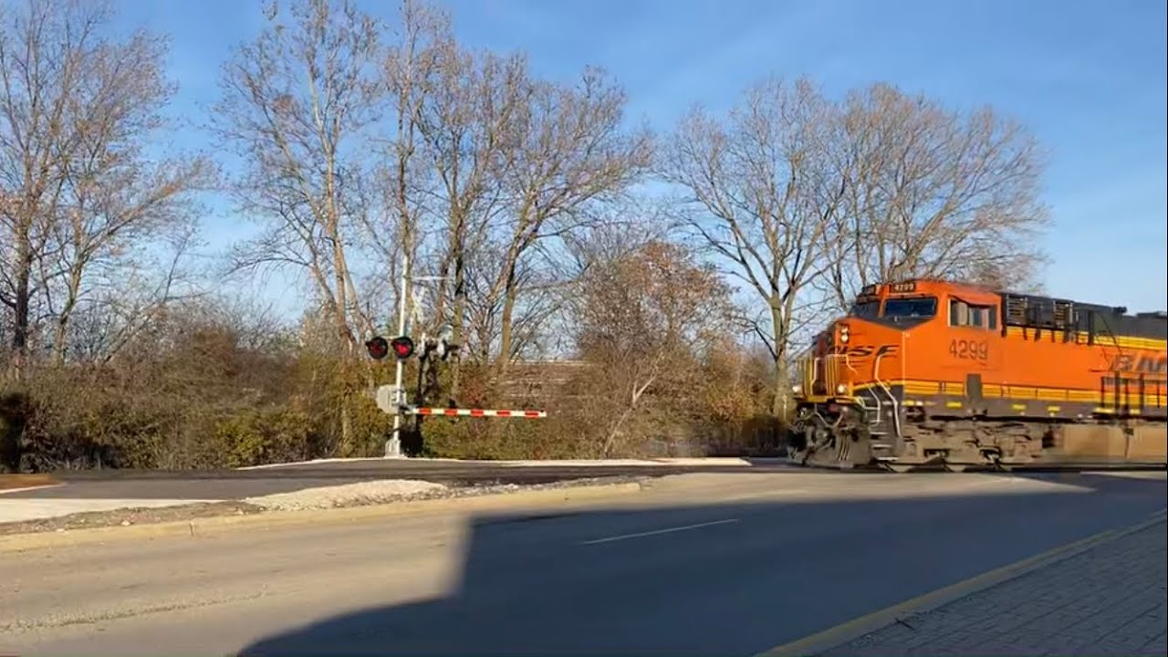 BNSF 4299 and 8136 lead a long manifest at Army Trail Road on the ...