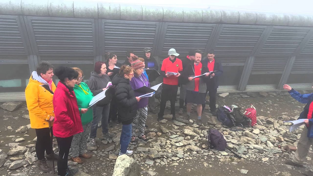 Cor alaw'r fenai singing at the top of snowdon - YouTube
